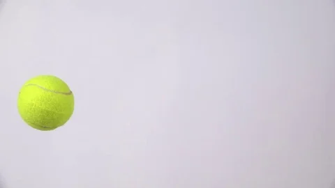 4K Tennis Ball Moves Slowly Across White... | Stock Video | Pond5