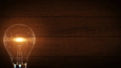 4K Thinking Light bulb . Wood background... | Stock Video | Pond5