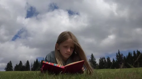 4K Thinking Sad Girl Reading a Book on M... | Stock Video | Pond5