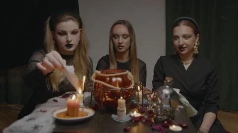4K. Three female witches in a dark room ... | Stock Video | Pond5