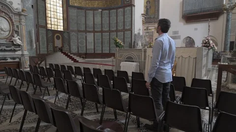 4K Vertical Pan Young man In A Cathedral | Stock Video | Pond5