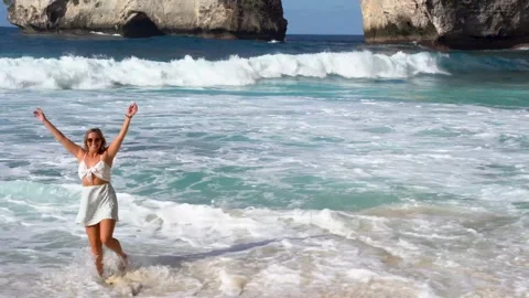 4k video of a girl running into the ocea... | Stock Video | Pond5