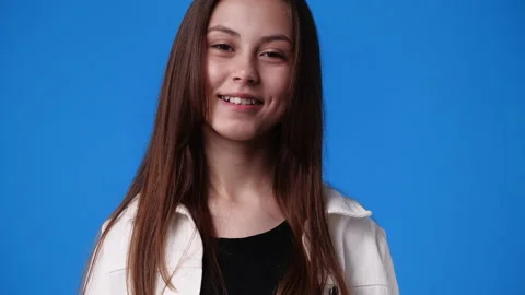 4k video of one cute girl smiling on blu... | Stock Video | Pond5