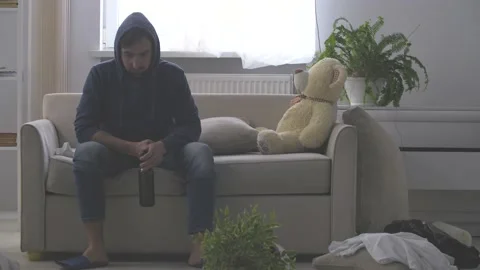 4k video where man sitting on the sofa l... | Stock Video | Pond5