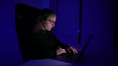 4K, Woman with headphones typing on her ... | Stock Video | Pond5