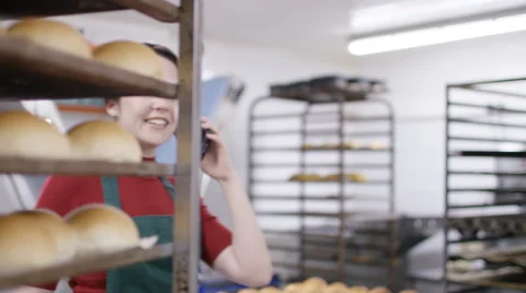 4K Worker in bakery kitchen talking on p... | Stock Video | Pond5