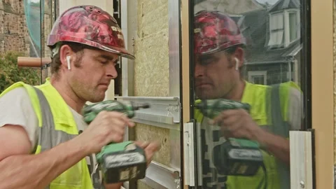 4k - Workman attaching cladding to a bui... | Stock Video | Pond5