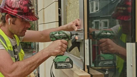 4k - Workman attaching cladding to a bui... | Stock Video | Pond5
