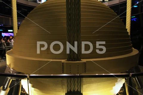 The 660-tonne golden steel pendulum which serves as a tuned mass damper ...