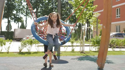 An 8-year-old boy is rocking a round swi... | Stock Video | Pond5