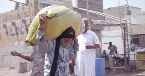 80 year old man lifting heavy sack on hi... | Stock Video | Pond5