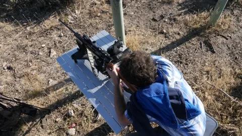 Above shot of a man shooting a rifle at ... | Stock Video | Pond5