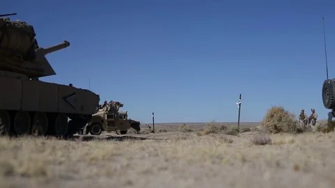 Abrams tanks pass parked Humvee armored ... | Stock Video | Pond5