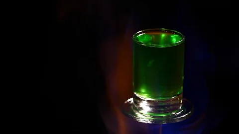 absinthe shot glass fire dark background... | Stock Video | Pond5