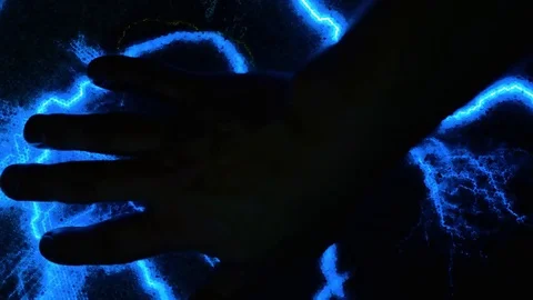 Abstract blue lightning. A man touches h... | Stock Video | Pond5