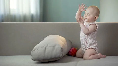 Active baby girl clapping hands and play... | Stock Video | Pond5