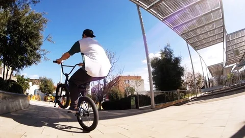 Active guy bmx rider is riding in street... | Stock Video | Pond5