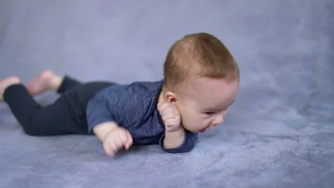 Active little baby boy turning from his ... | Stock Video | Pond5