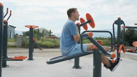 Active man exercising at outdoor gym. Yo... | Stock Video | Pond5