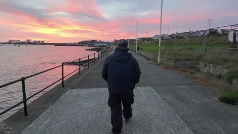 Active man walking alone on harbour brea... | Stock Video | Pond5