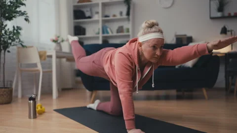 Active woman in her 50s working out on f... | Stock Video | Pond5