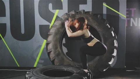 Active woman jumping on training tire at... | Stock Video | Pond5