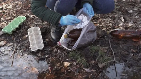 Activists collect garbage in the park an... | Stock Video | Pond5
