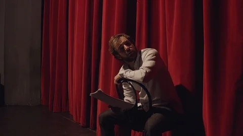 Actor in a theatre reviewing the script | Stock Video | Pond5