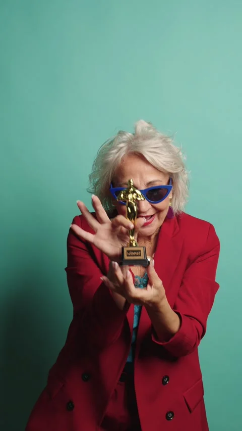 Actress joyfully posing with award in a ... | Stock Video | Pond5