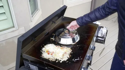 Adding cheese on top of the eggs to make... | Stock Video | Pond5