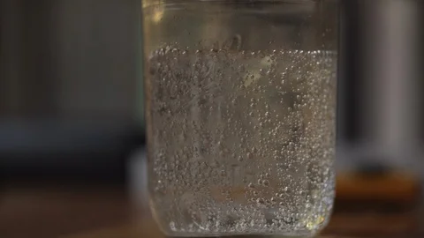 Adding more sparkling water to a glass w... | Stock Video | Pond5