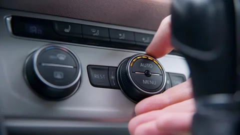Adjusting temperature on ac button on ca... | Stock Video | Pond5