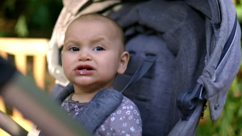 Adorable and concerned baby in gray stro... | Stock Video | Pond5