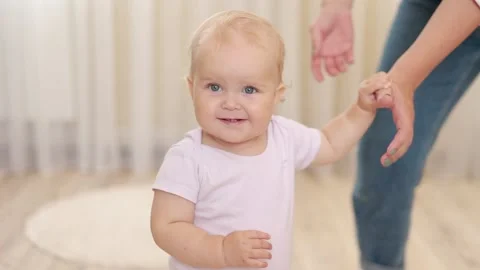 Adorable baby girl learning to walk todd... | Stock Video | Pond5