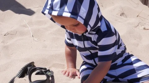 Adorable boy playing on sandy beach in f... | Stock Video | Pond5
