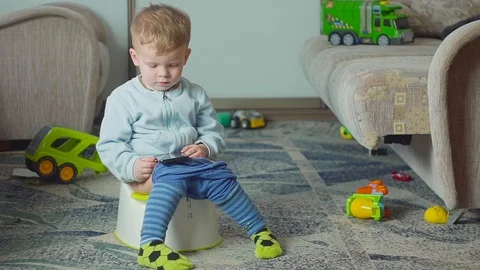 Adorable boy with a smartphone during po... | Stock Video | Pond5