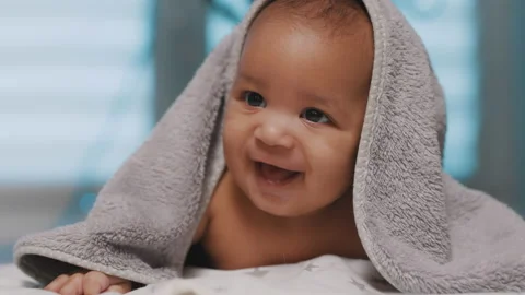 Adorable dark skin baby covered with tow... | Stock Video | Pond5