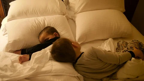Adorable little brothers sleep on top of... | Stock Video | Pond5