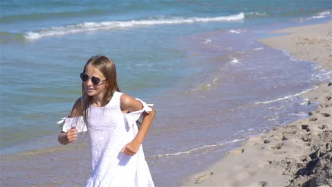 Adorable little girl at beach during sum... | Stock Video | Pond5