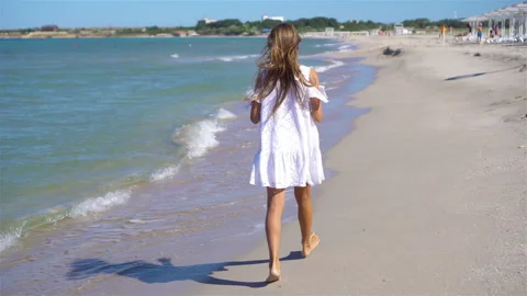 Adorable little girl at beach during sum... | Stock Video | Pond5
