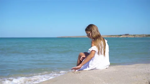 Adorable little girl at beach during sum... | Stock Video | Pond5