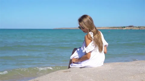 Adorable little girl at beach during sum... | Stock Video | Pond5