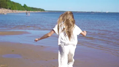Adorable little girl at beach during sum... | Stock Video | Pond5