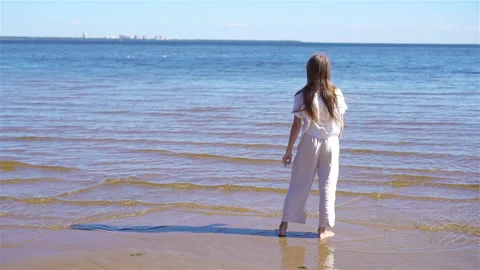 Adorable little girl at beach during sum... | Stock Video | Pond5
