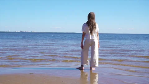 Adorable little girl at beach during sum... | Stock Video | Pond5