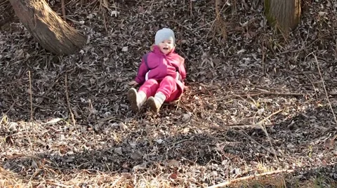 Adorable little girl falling down in th... | Stock Video | Pond5