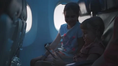 Adorable little girls travel by plane. C... | Stock Video | Pond5