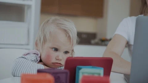Adorable toddler child looks carefully a... | Stock Video | Pond5