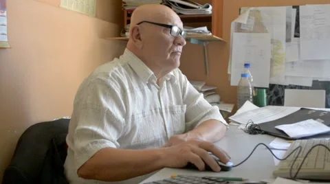 adult bald man working at a computer | Stock Video | Pond5