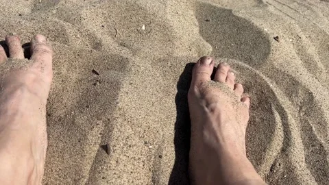 Adult bare feet playing in the sand | Stock Video | Pond5